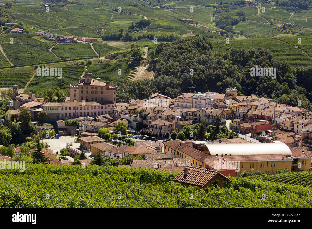 View of the historical town of Barolo among green hills and vineyards ...