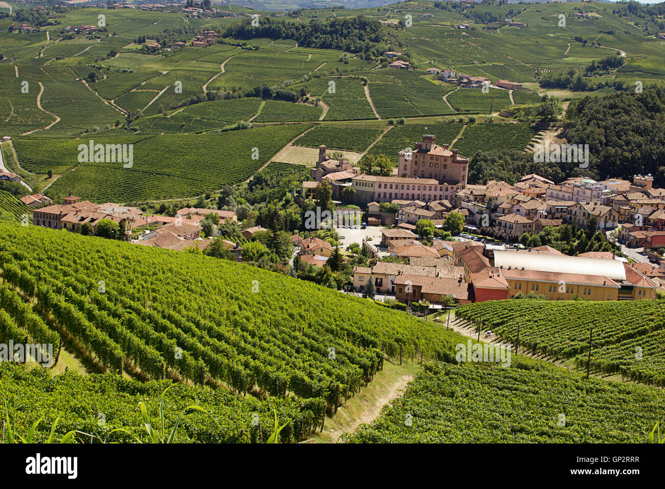 View of the historical town of Barolo among green hills and vineyards ...