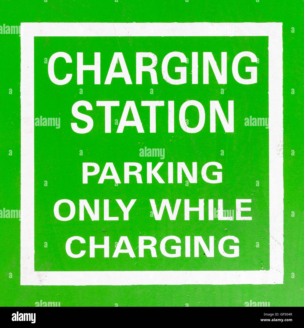 Electric Vehicle Charging Station green road sign. Parking only while ...