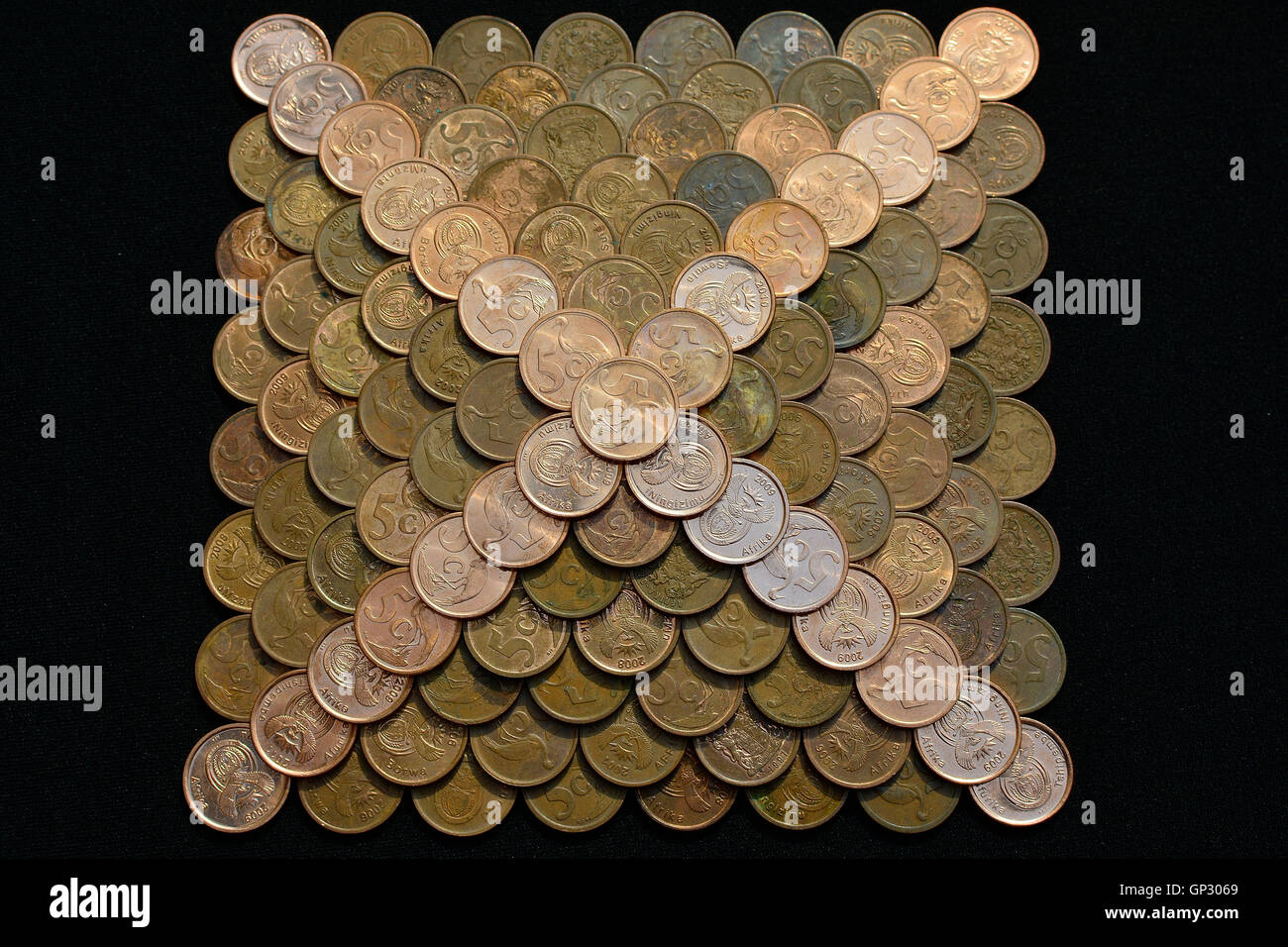 Pyramid of coins also forming a cross. Pyramid scheme Stock Photo - Alamy