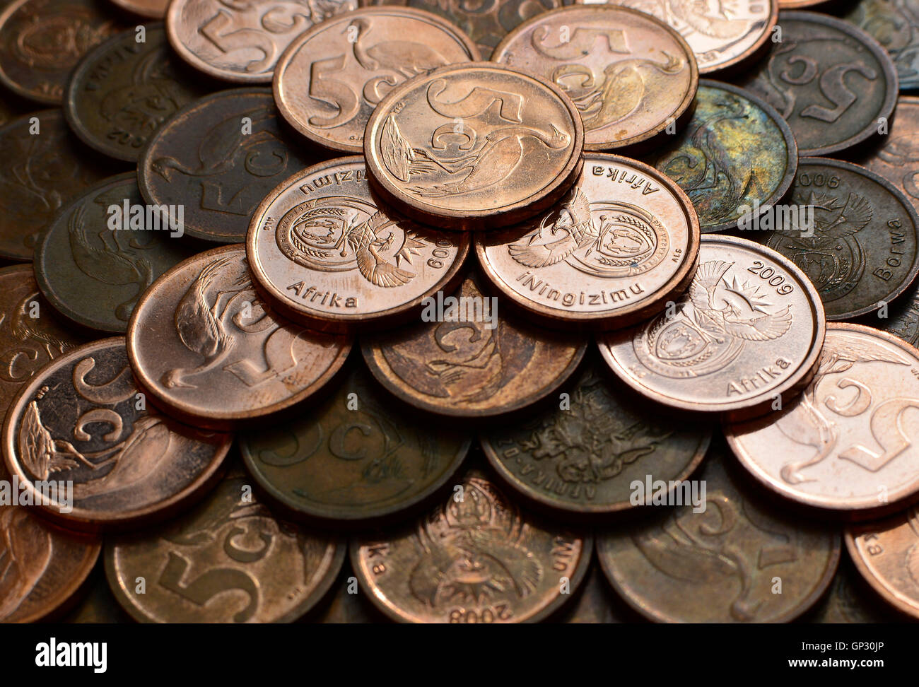 Pyramid of coins also forming a cross. Pyramid scheme Stock Photo - Alamy