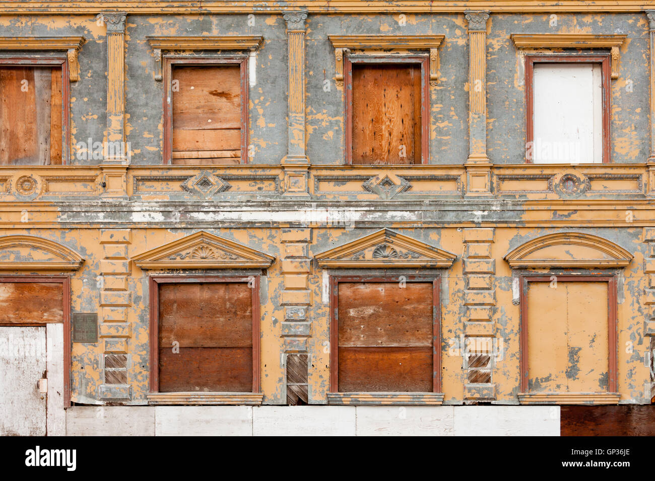 Boarded up derelict building facade peeling paint Stock Photo - Alamy