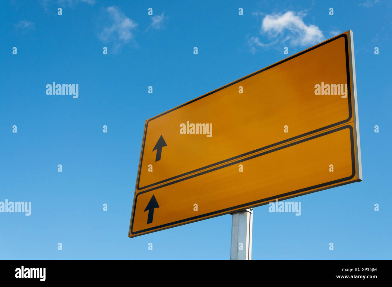 Yellow road sign with arrows on sky background Stock Photo - Alamy