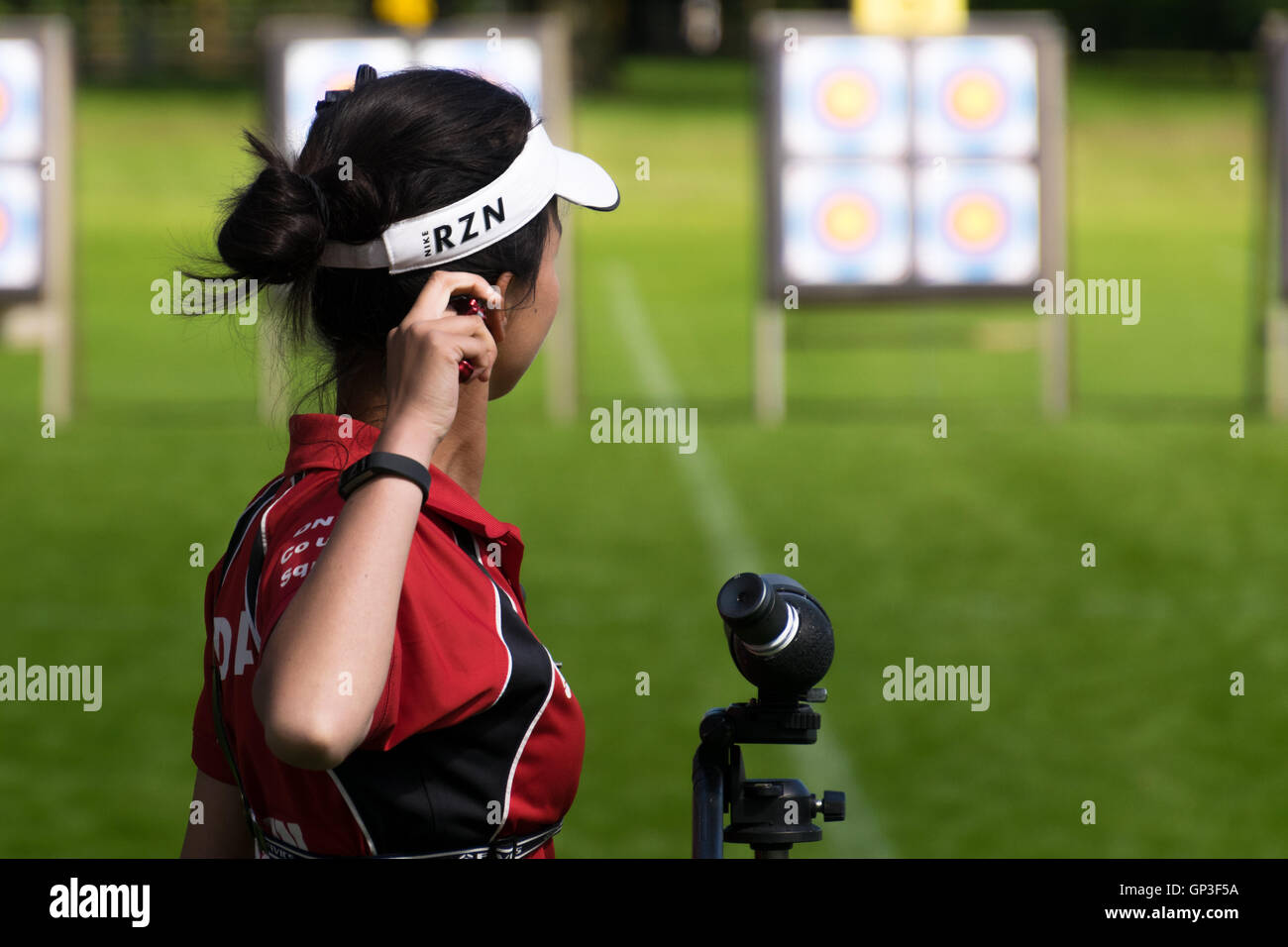 Young female compound archer and target in competition Stock Photo - Alamy