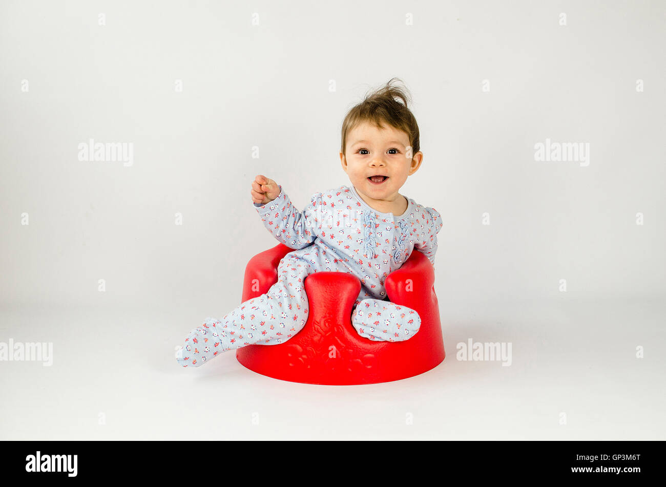 cute baby girl sitting in a sitter and making funny expressions Stock ...