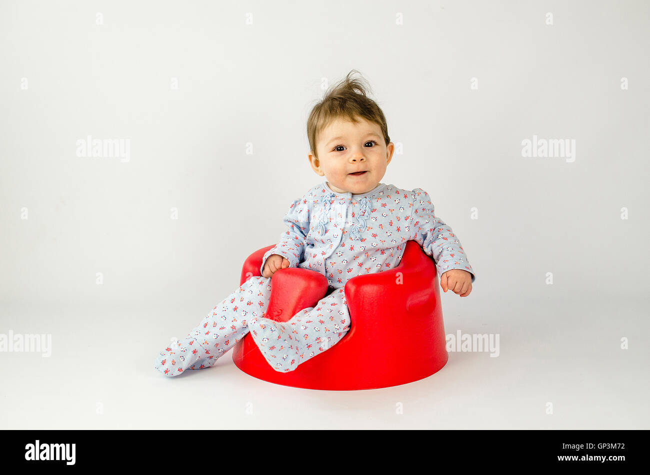 cute baby girl sitting in a sitter and making funny expressions Stock ...