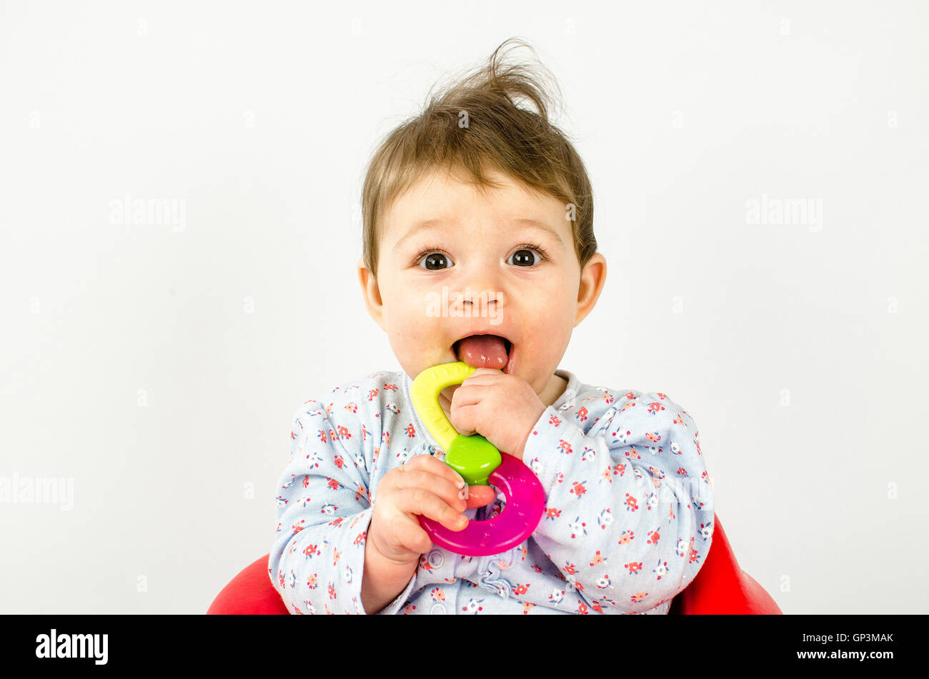 adorable baby girl teething and chewing teethers Stock Photo - Alamy