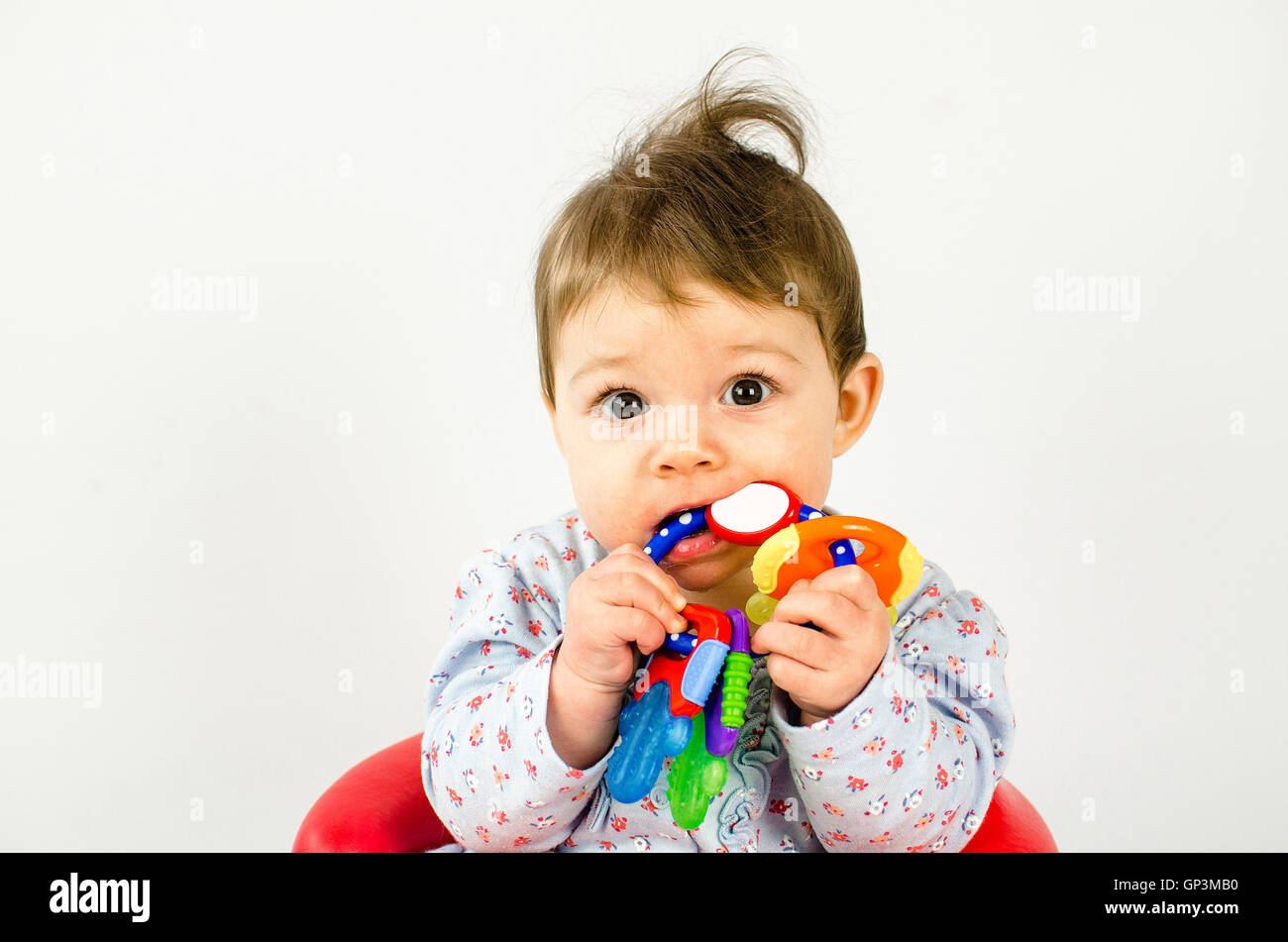 adorable baby girl teething and chewing teethers Stock Photo - Alamy