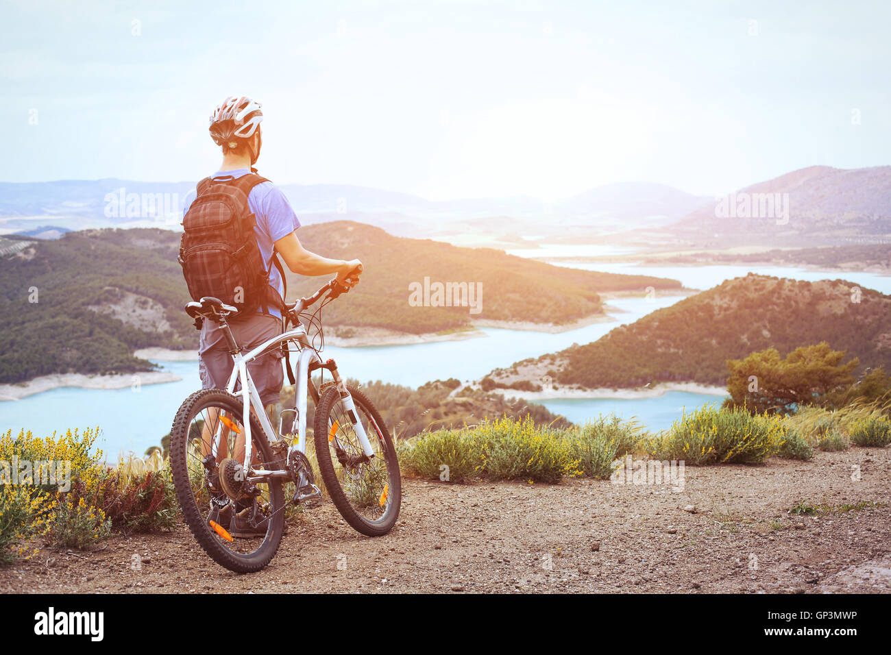 cycling, mountain biking, man with bicycle enjoying panoramic view at ...