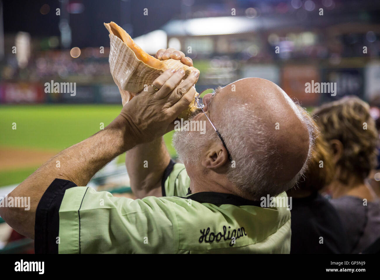 Fort Wayne, Indiana - A baseball fan celebrates by blowing into a queen ...