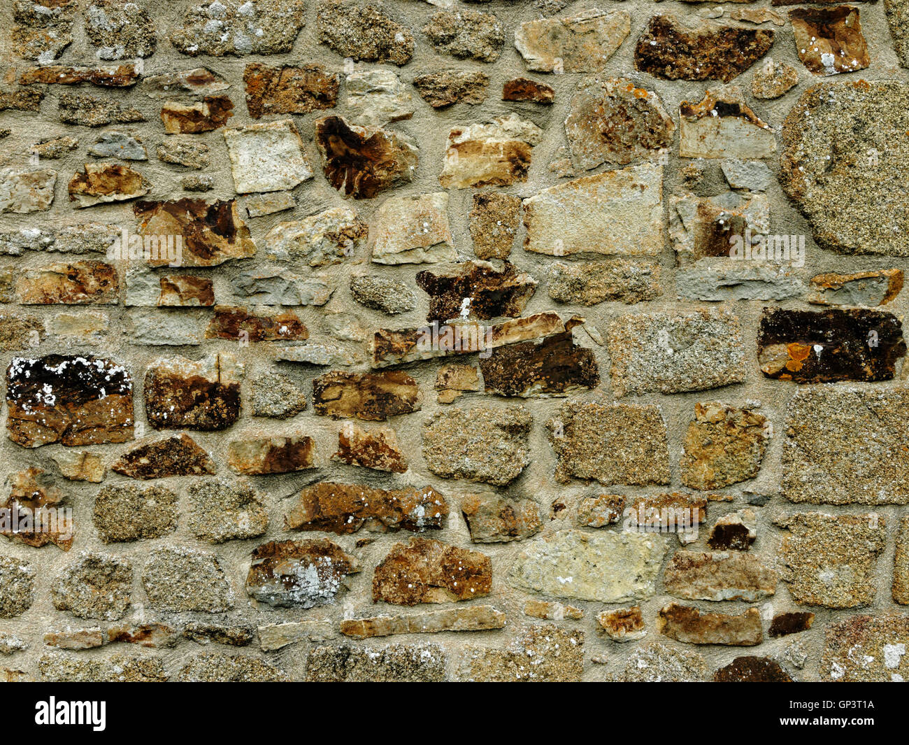 Rustic sandstone wall of the abbey church at Lonlay L'Abbeye in the ...