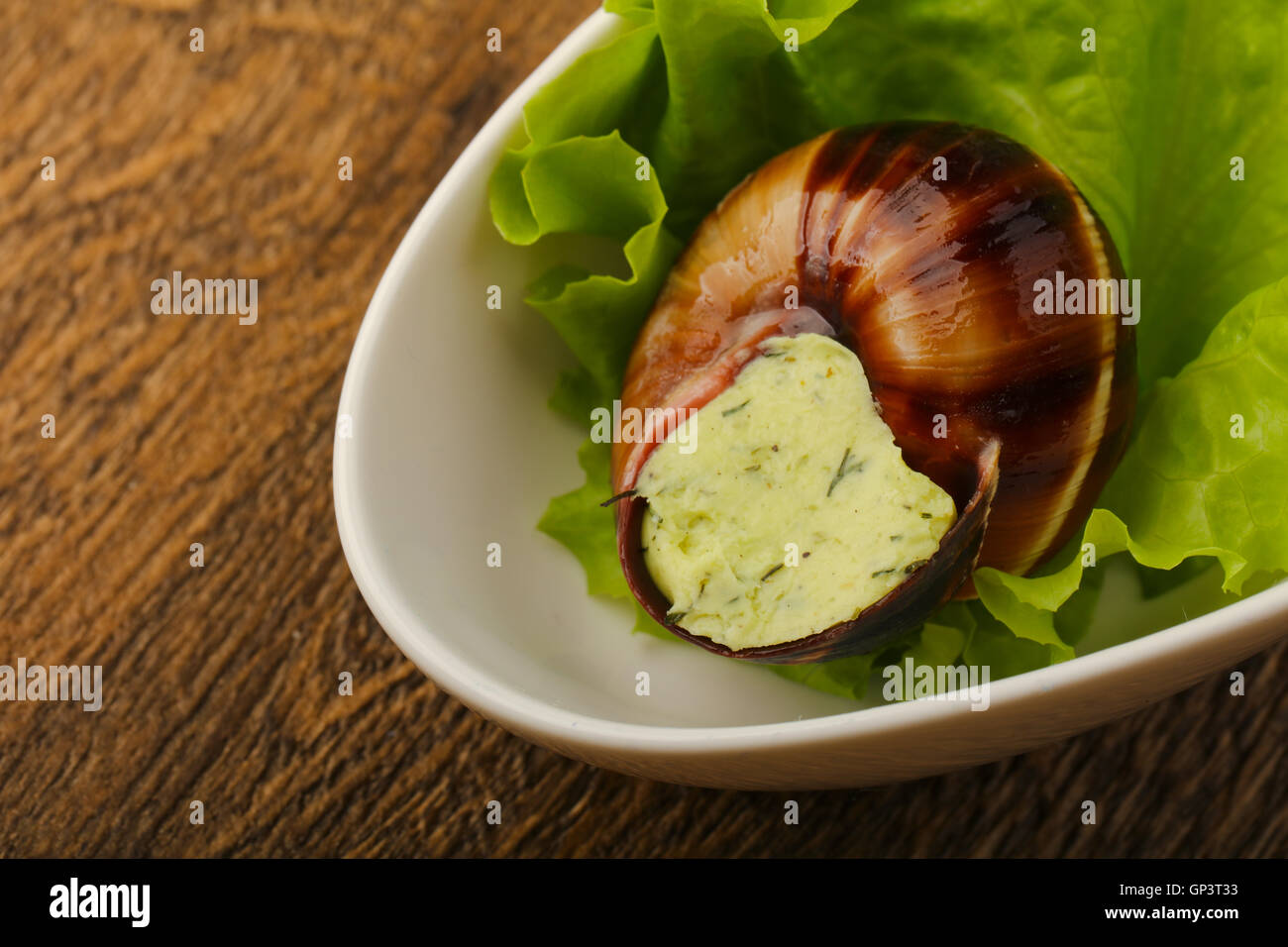 Escargot with cheese cream on salad leaves Stock Photo - Alamy