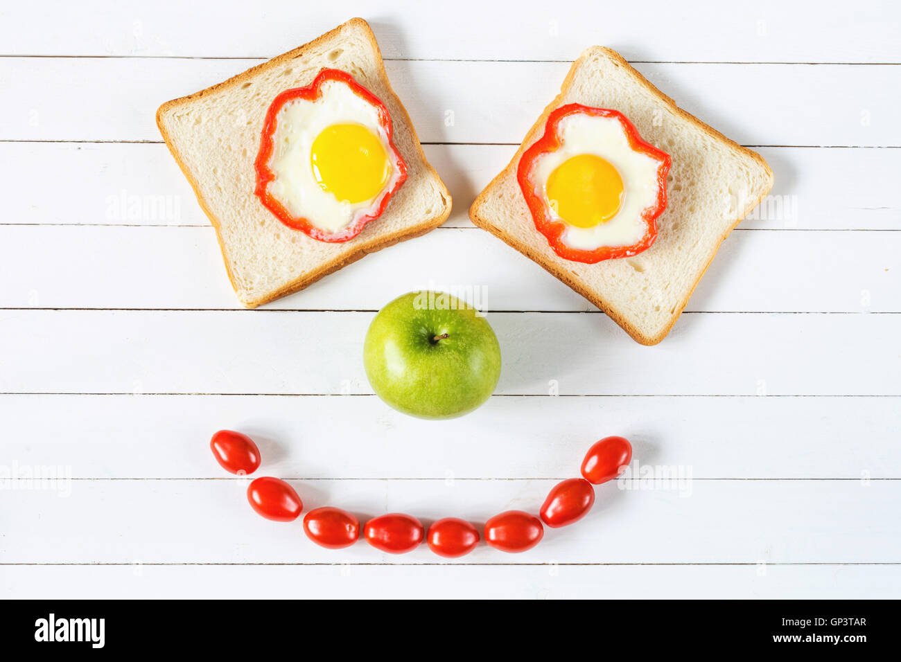 Smiling food face. Breakfast food concept, egg sandwich, apple and ...