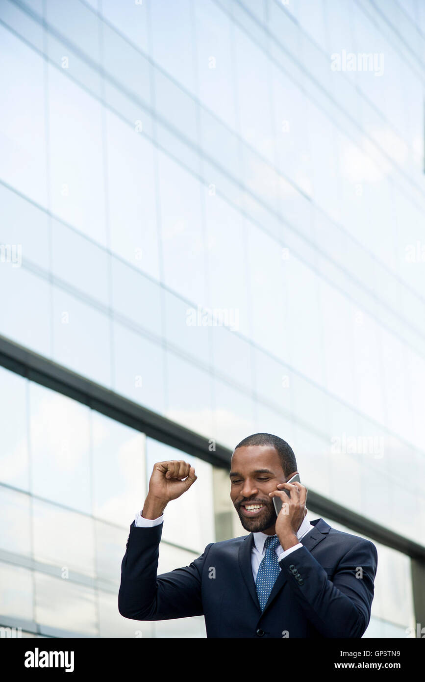 Businessman receiving good news during cell phone call Stock Photo - Alamy