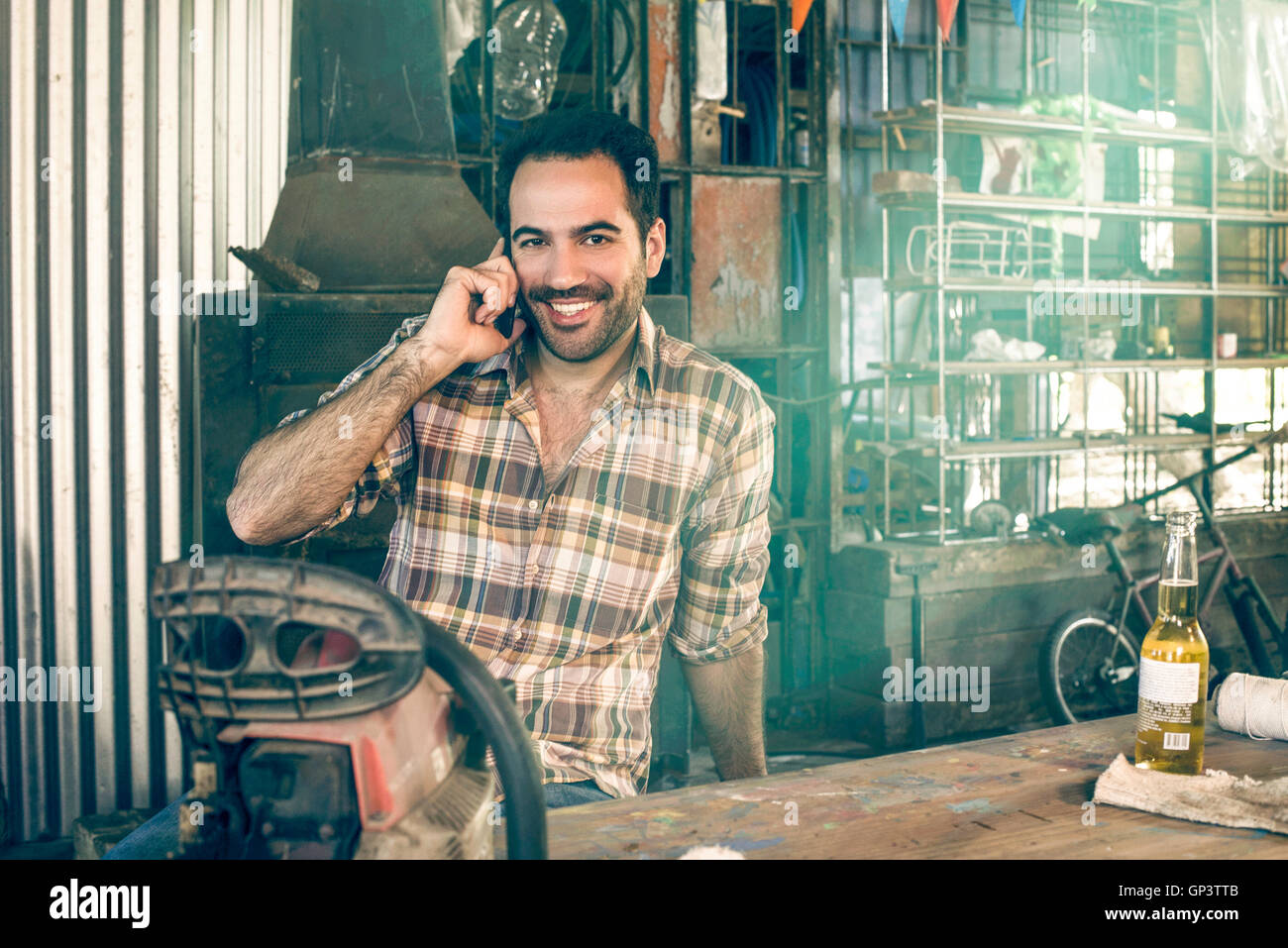 Man taking break for phone call and beer Stock Photo - Alamy