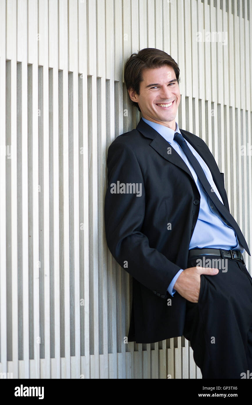 Businessman leaning wall eyes hi-res stock photography and images - Alamy
