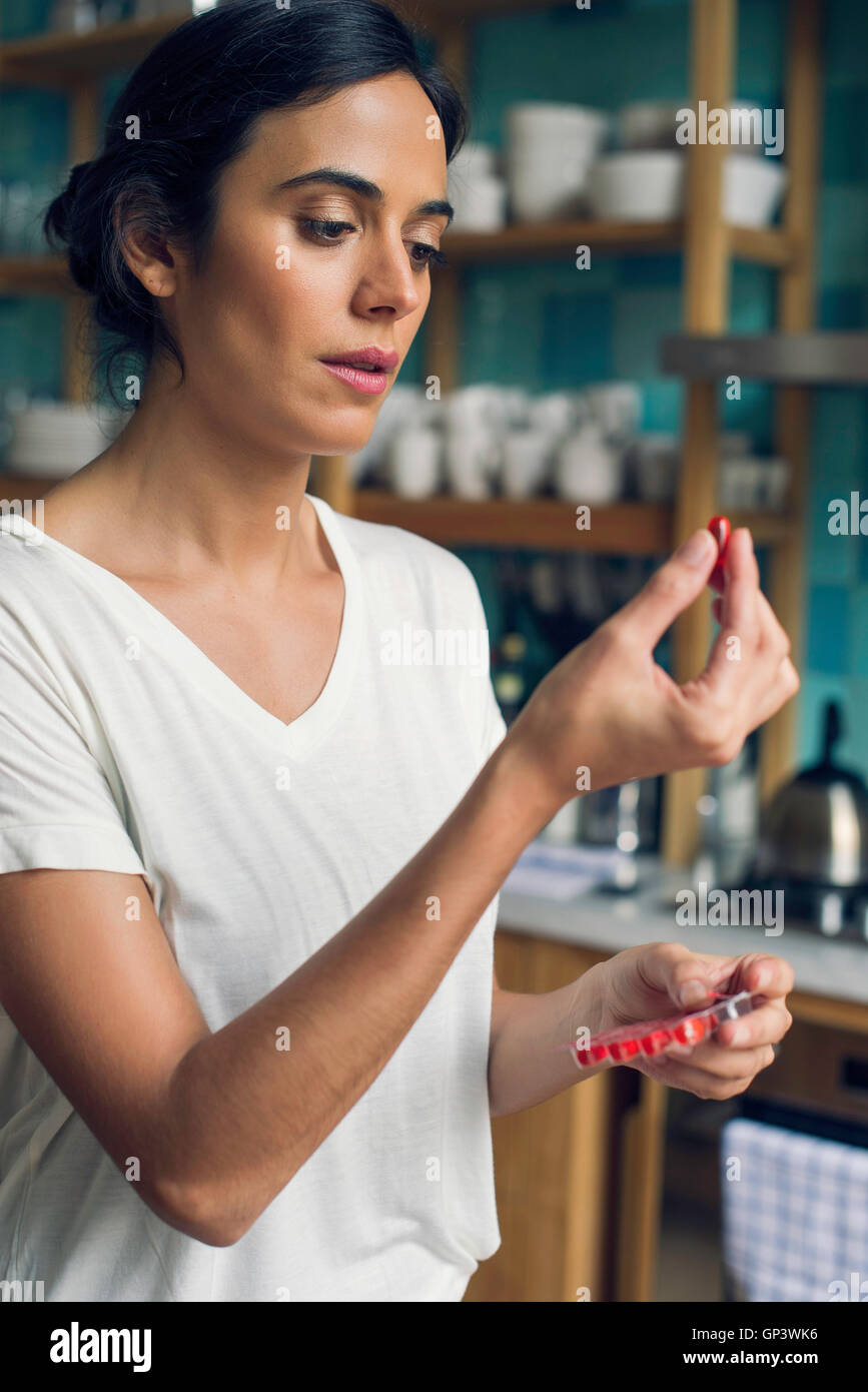 Woman taking medication Stock Photo - Alamy