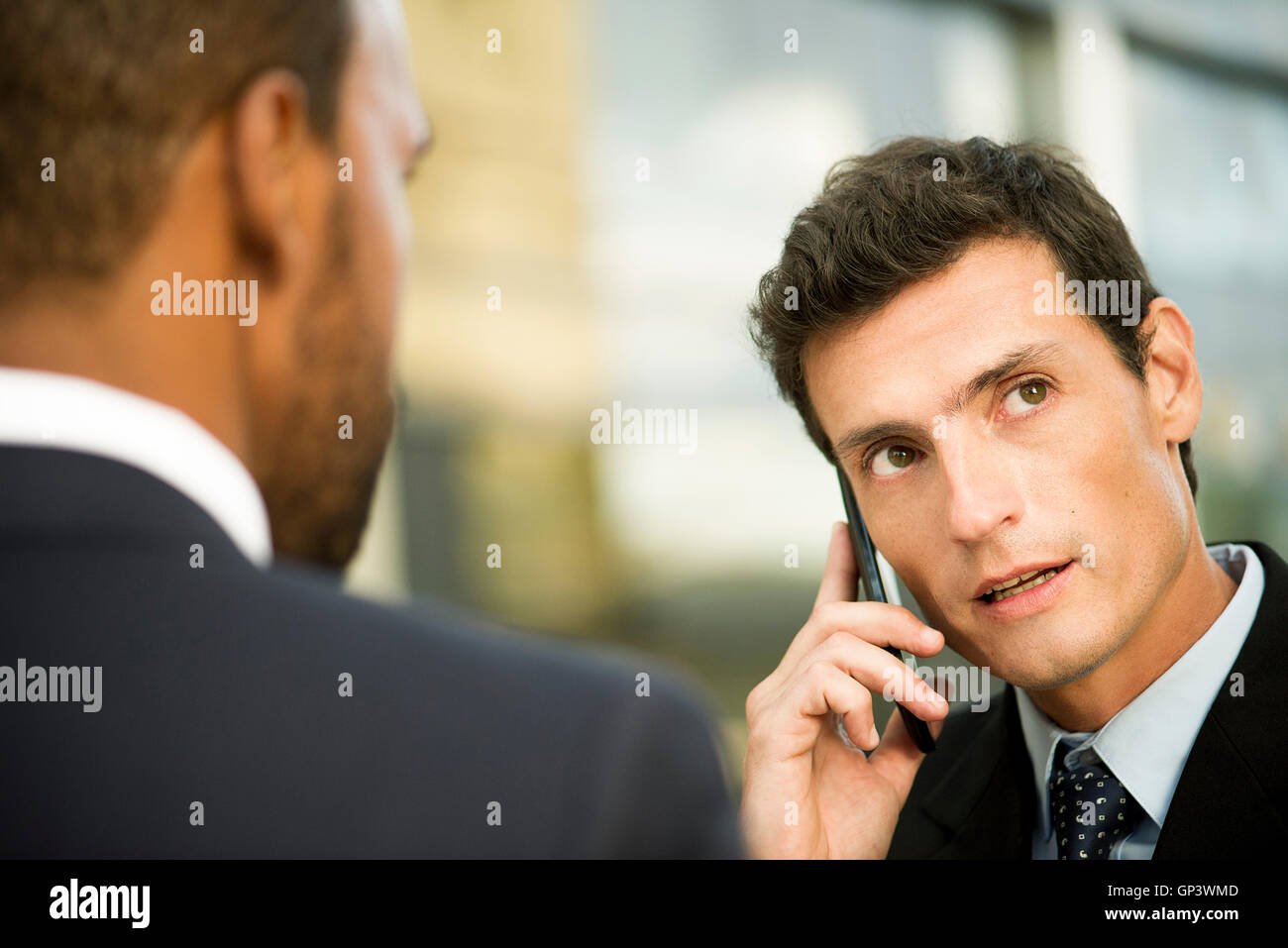 Two businessmen using cell phones hi-res stock photography and images - Alamy