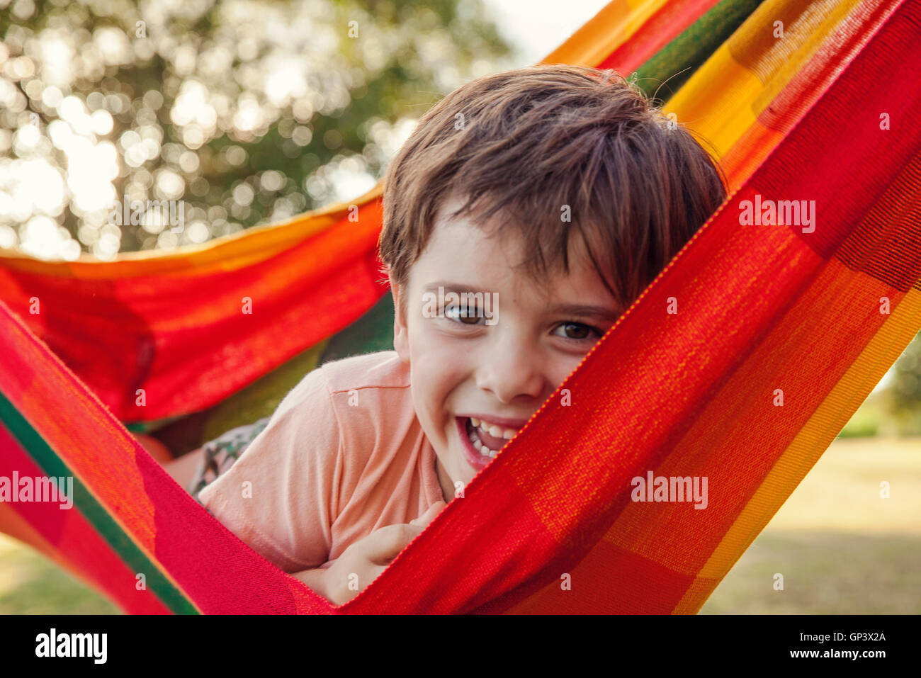 Boy lying in hammock, portrait Stock Photo - Alamy