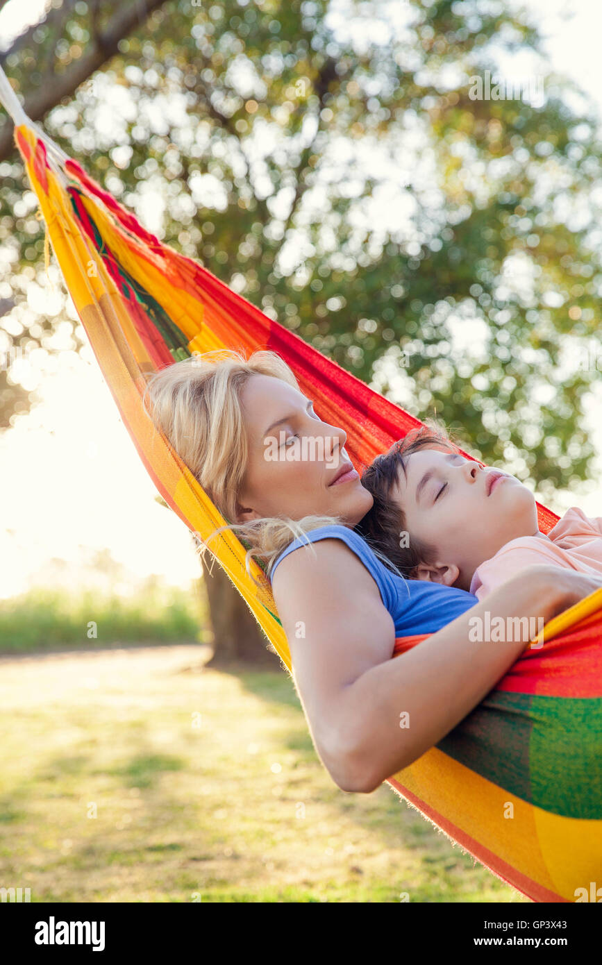 Mother and son napping together in hammock Stock Photo - Alamy