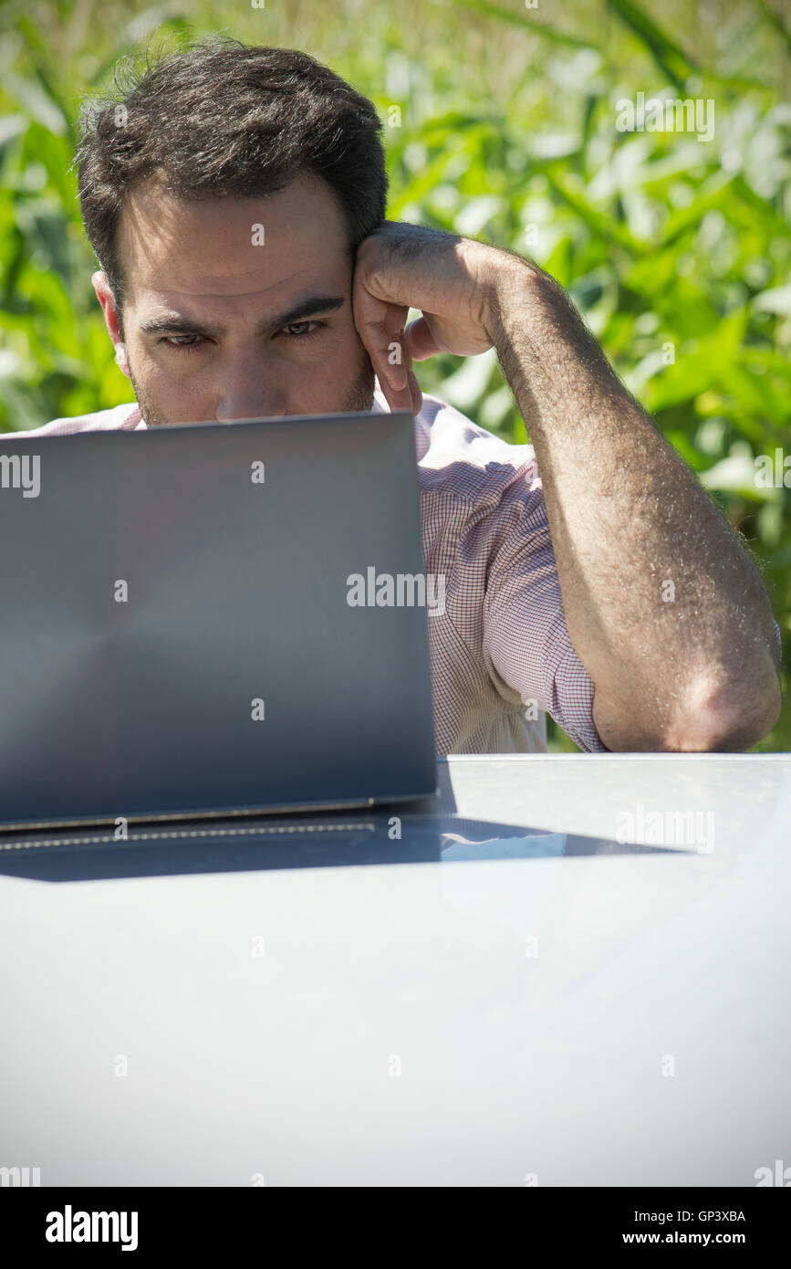 Man using laptop computer outdoors Stock Photo - Alamy