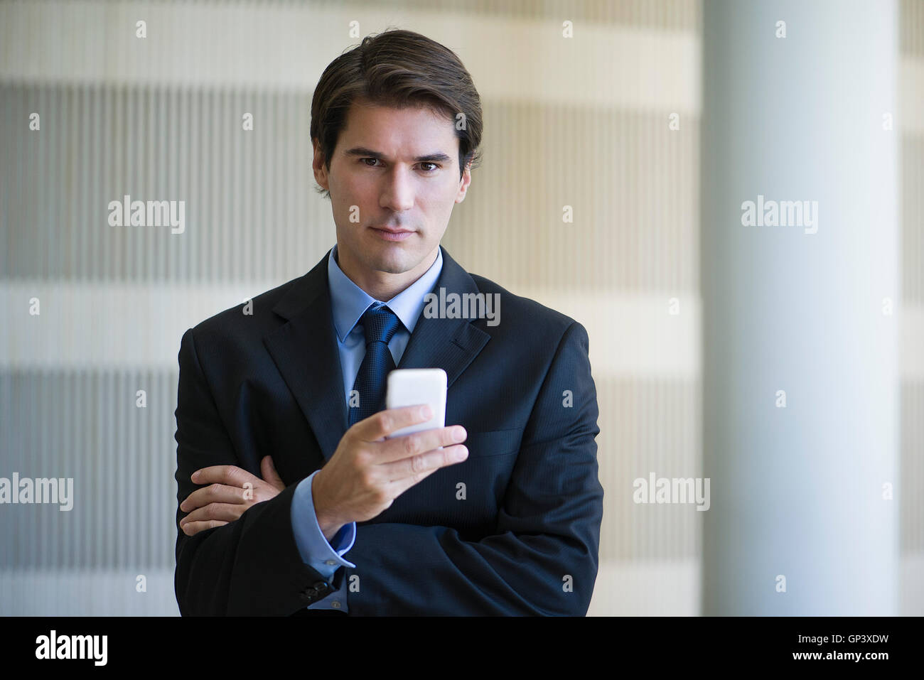 Businessman text messaging with cell phone, portrait Stock Photo - Alamy