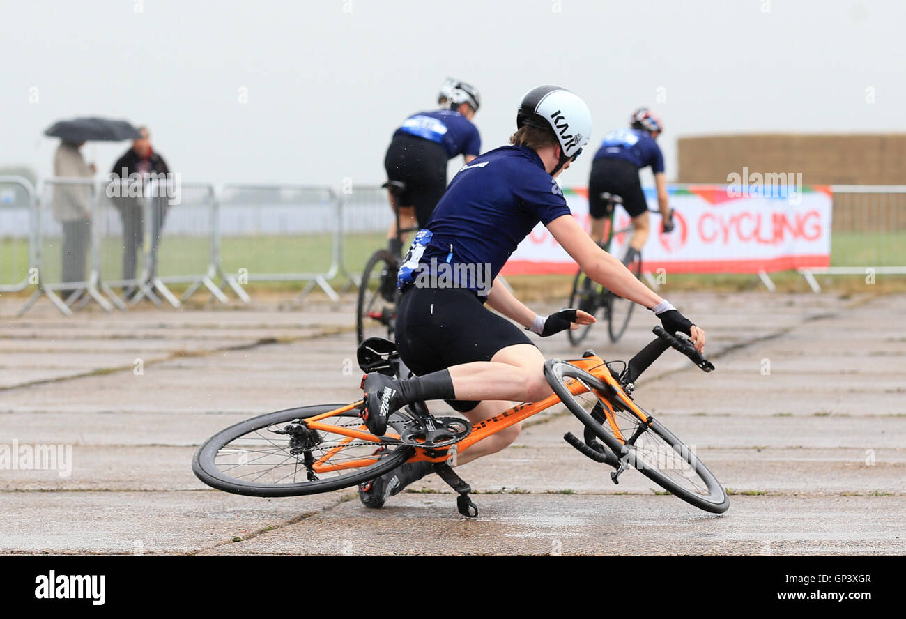 A cyclist falls off his bike during the team time trial road cycling on ...