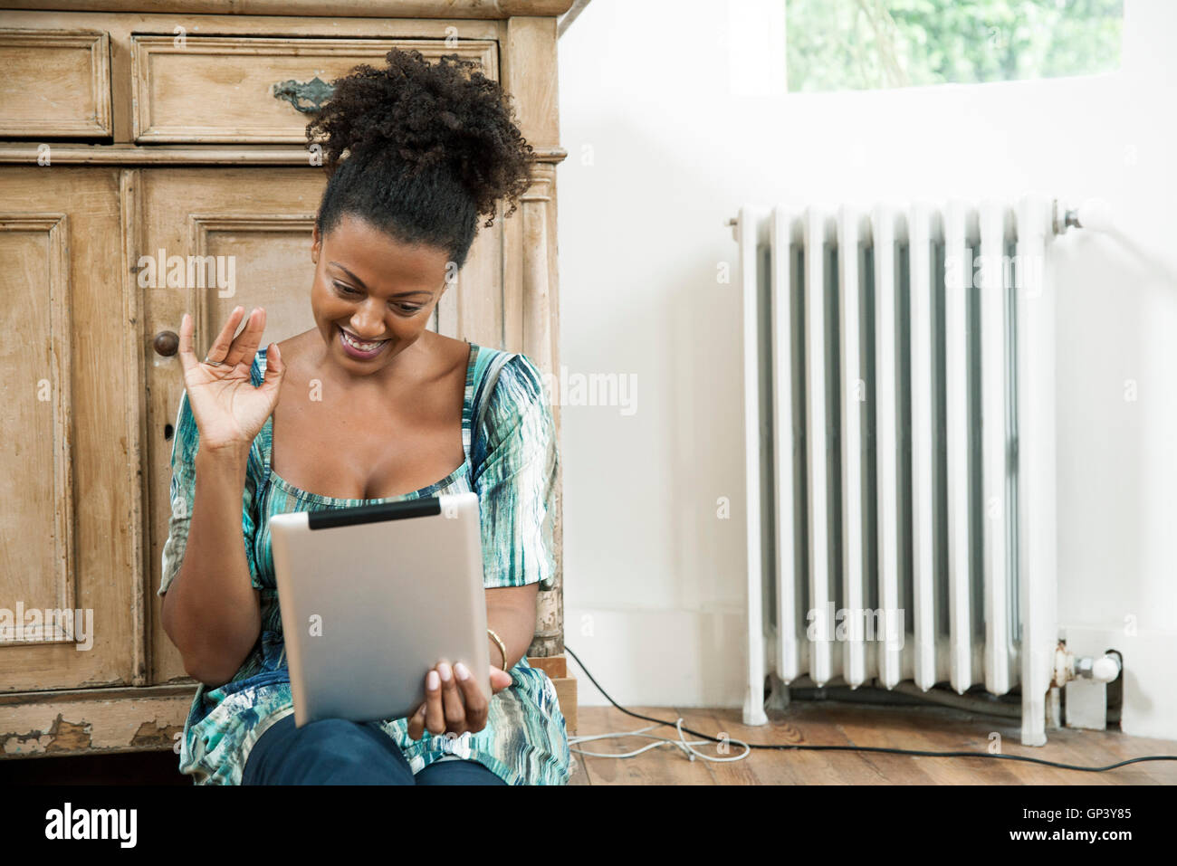 Woman sitting on radiator hi-res stock photography and images - Alamy