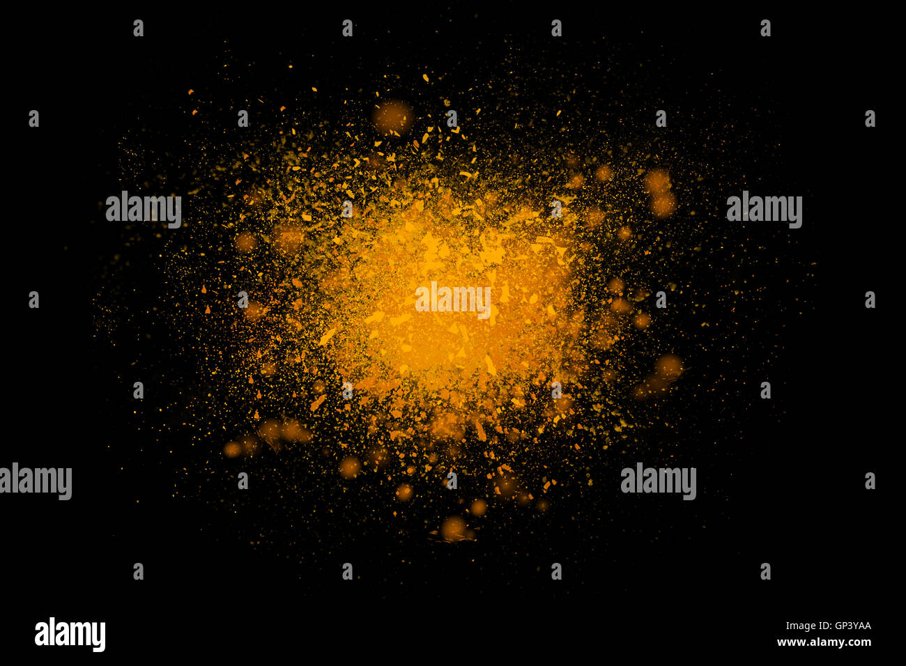 Freeze motion of colorful yellow powder exploding isolated on black ...