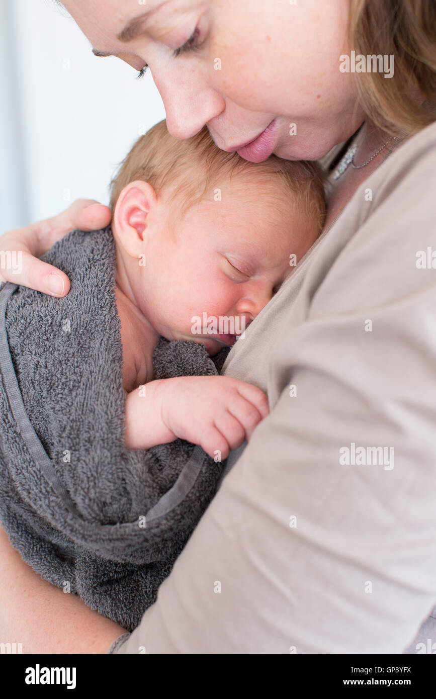Mother holding infant Stock Photo - Alamy