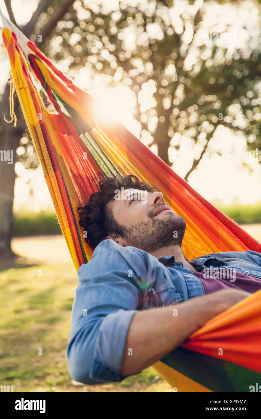 Man relaxing in hammock Stock Photo - Alamy