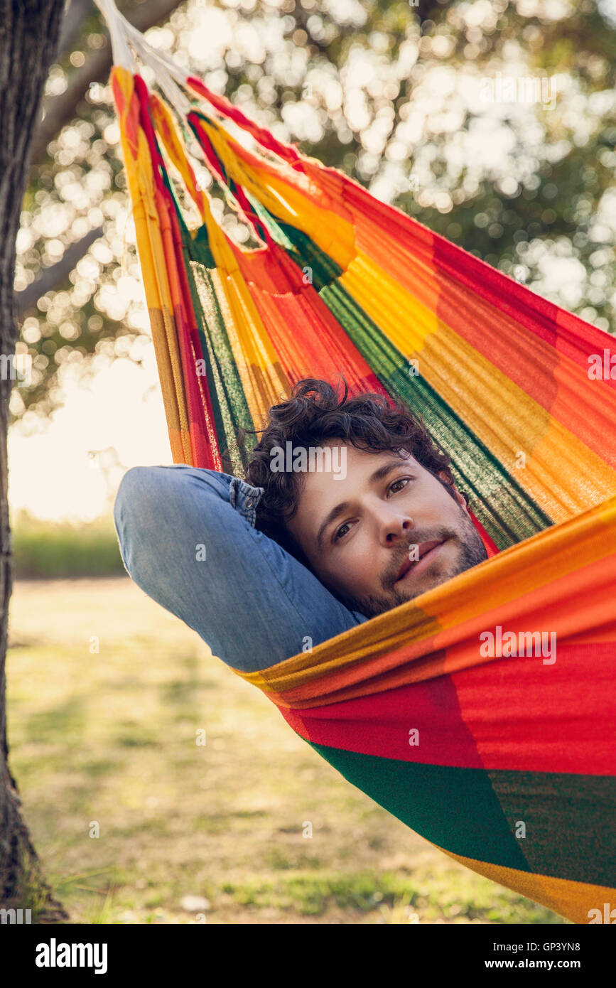 Man relaxing in hammock, portrait Stock Photo - Alamy