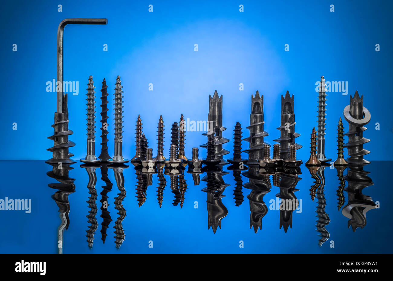 Collection of screws and bolts arranged as night time city skyline with ...