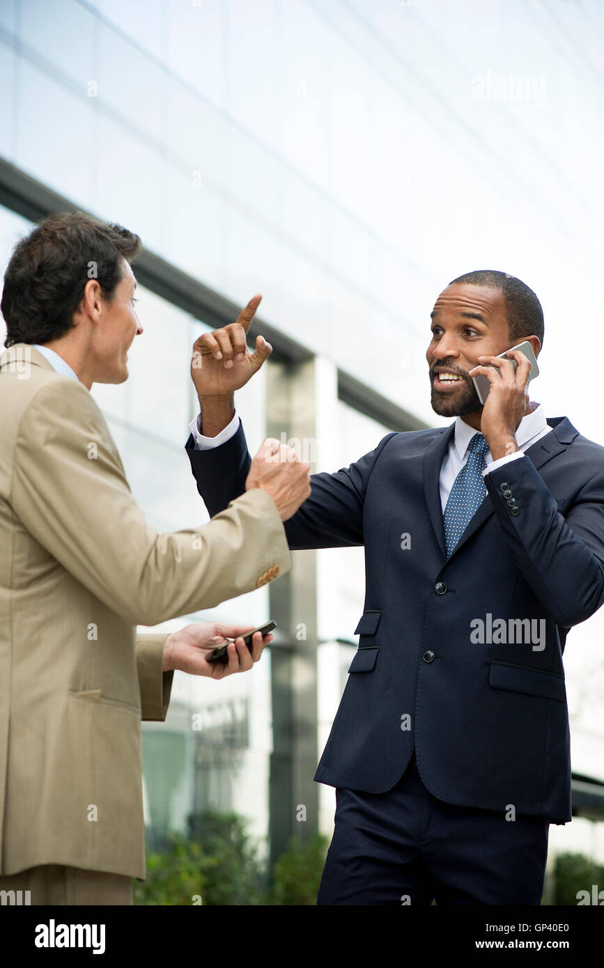 Businessmen celebrating good news Stock Photo - Alamy