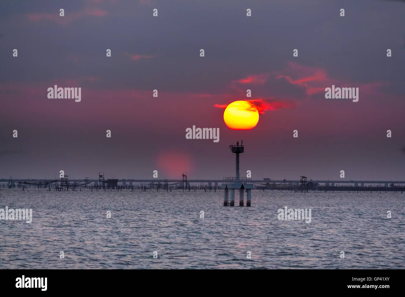 Partly cloudy sunset reflection sea Stock Photo - Alamy