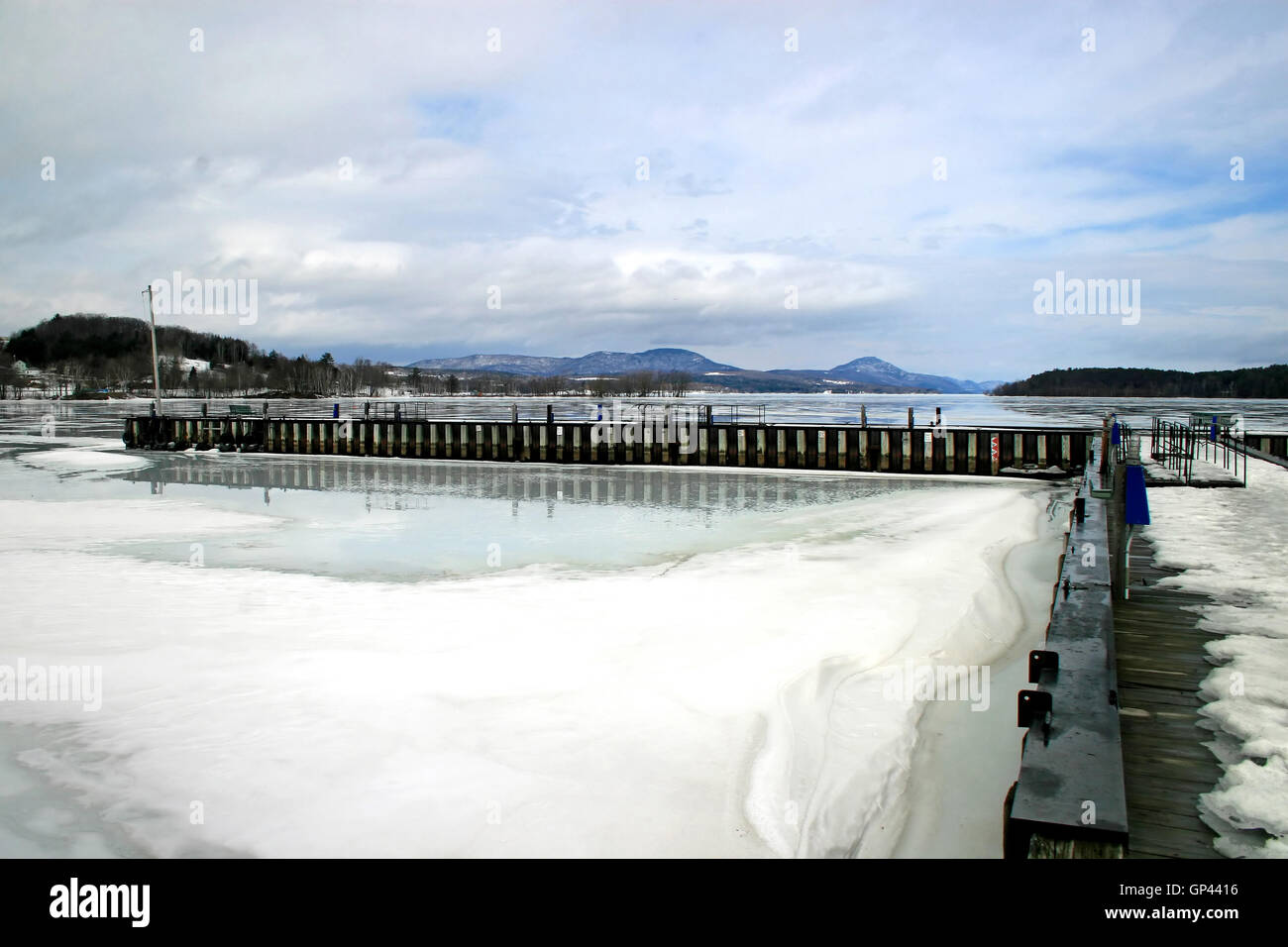 A dock and lake iced over in the winter Stock Photo - Alamy