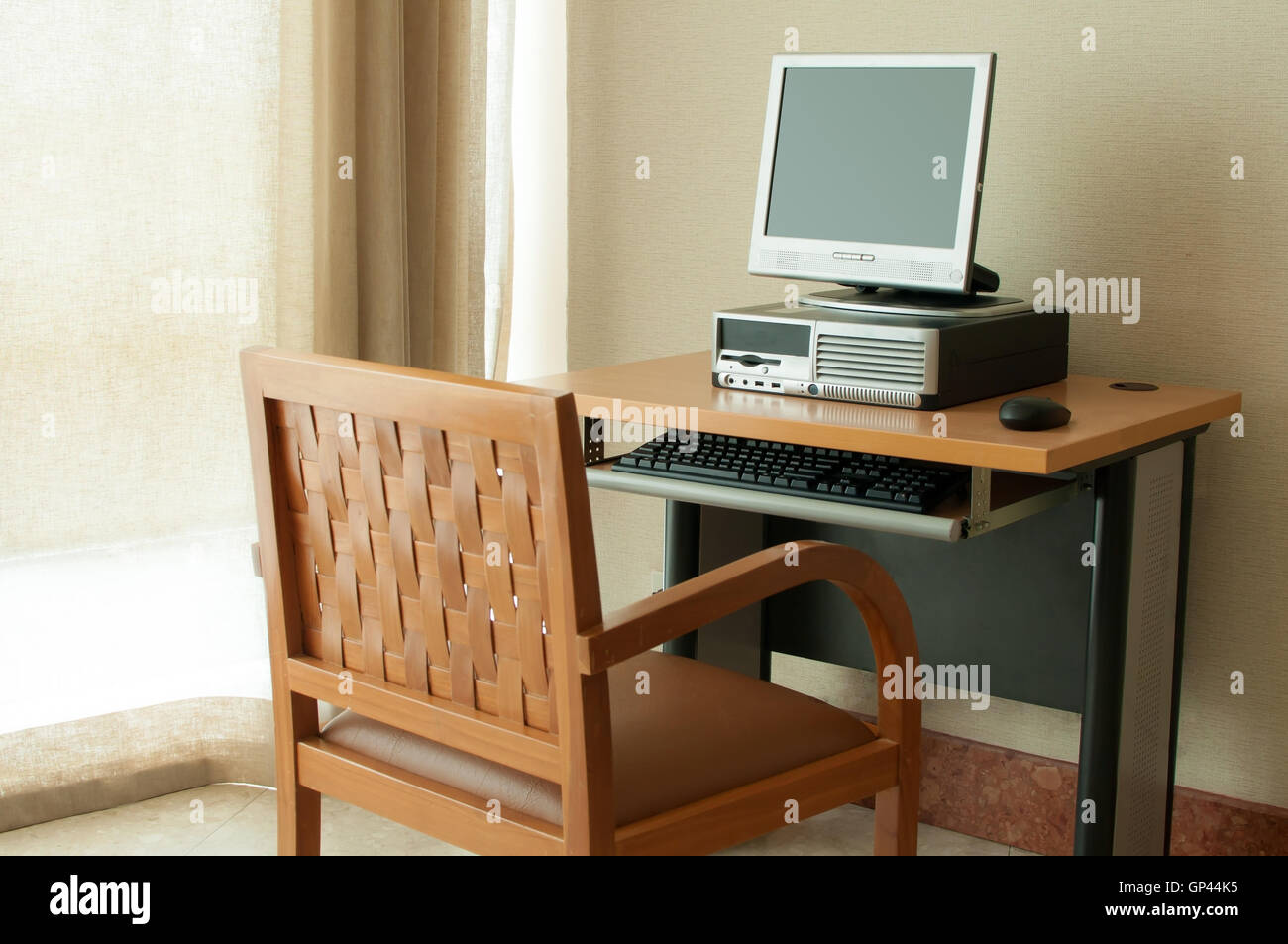 Workstation computer on table and wooden chair Stock Photo - Alamy