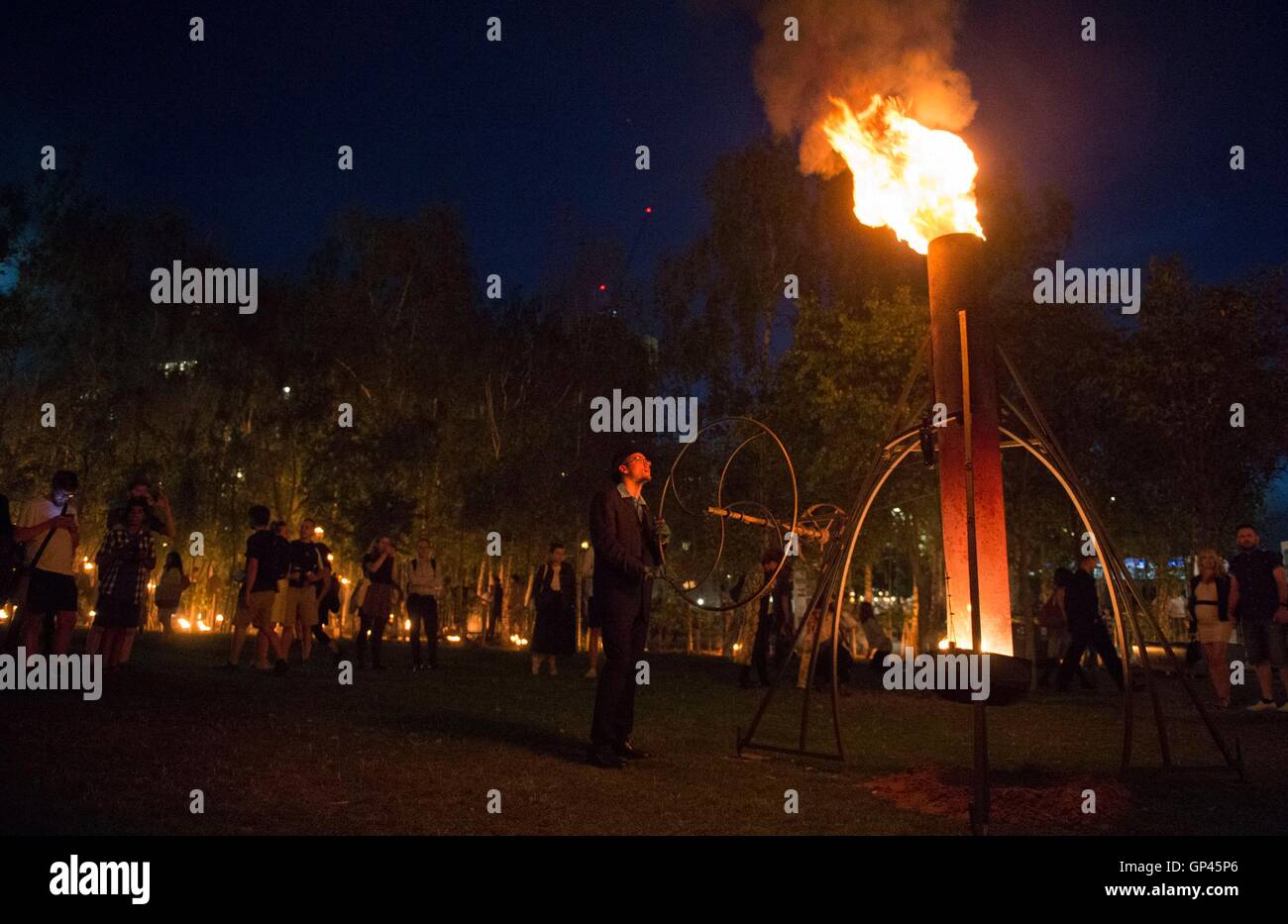 A member of staff attends to a burning structure as a part of 'Fire ...