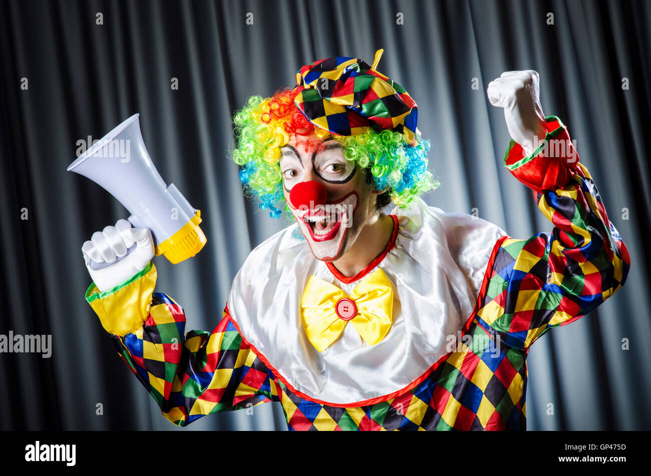 Clown in studio with loudspeaker Stock Photo - Alamy