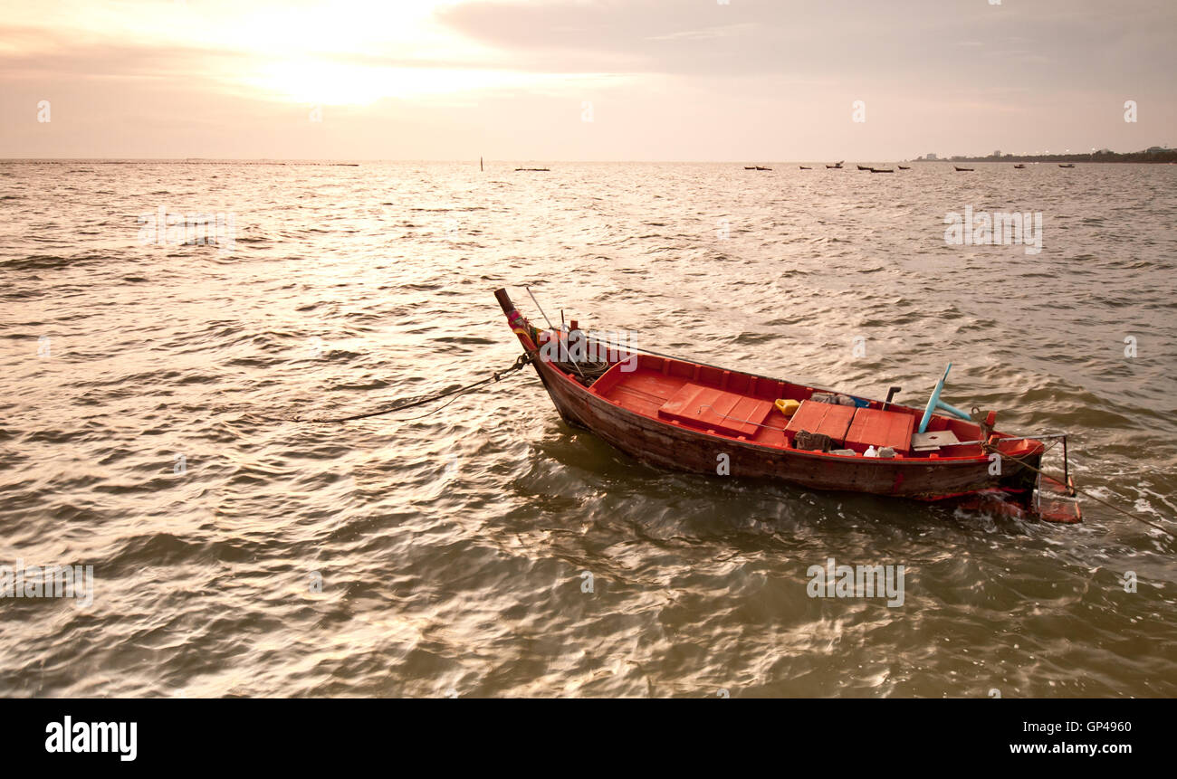 A small wooden fishing boat floating in the sea Stock Photo - Alamy