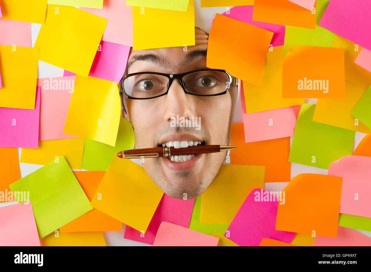 Man's face through paper and reminders Stock Photo - Alamy