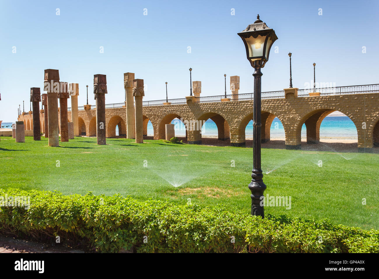 The arched stone colonnade with lanterns Stock Photo - Alamy