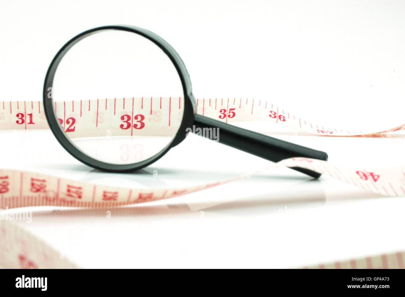 Magnifier and meter tape Stock Photo - Alamy