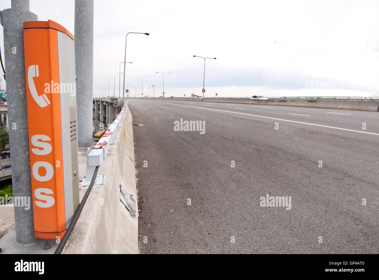 SOS sign and phone box on highway Stock Photo - Alamy