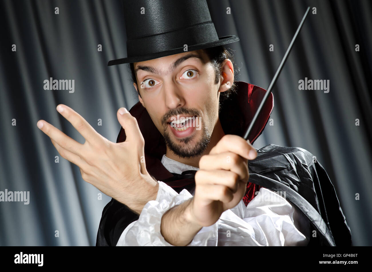 Magician doing tricks on white Stock Photo - Alamy