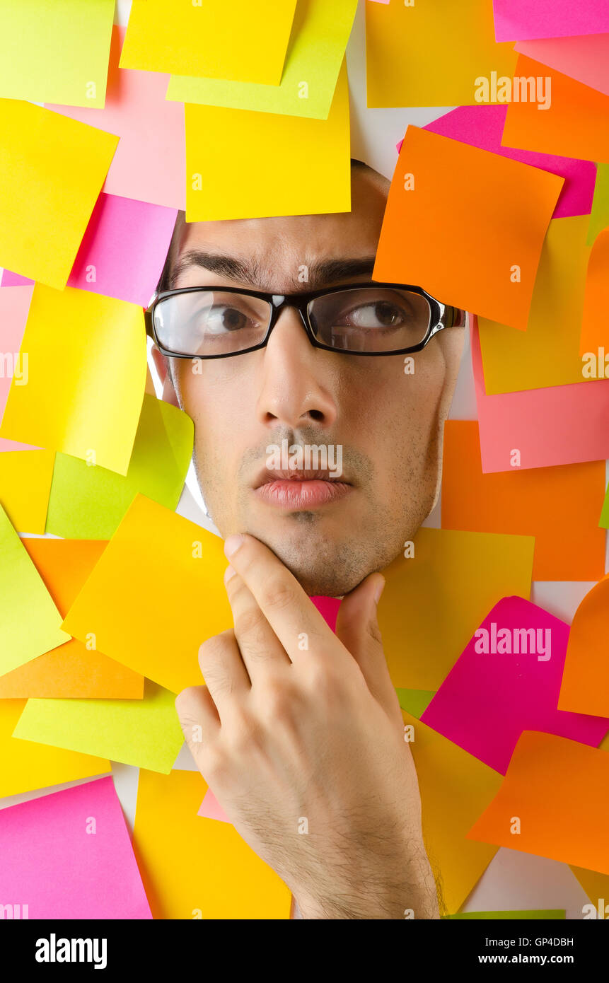 Man's face through paper and reminders Stock Photo - Alamy