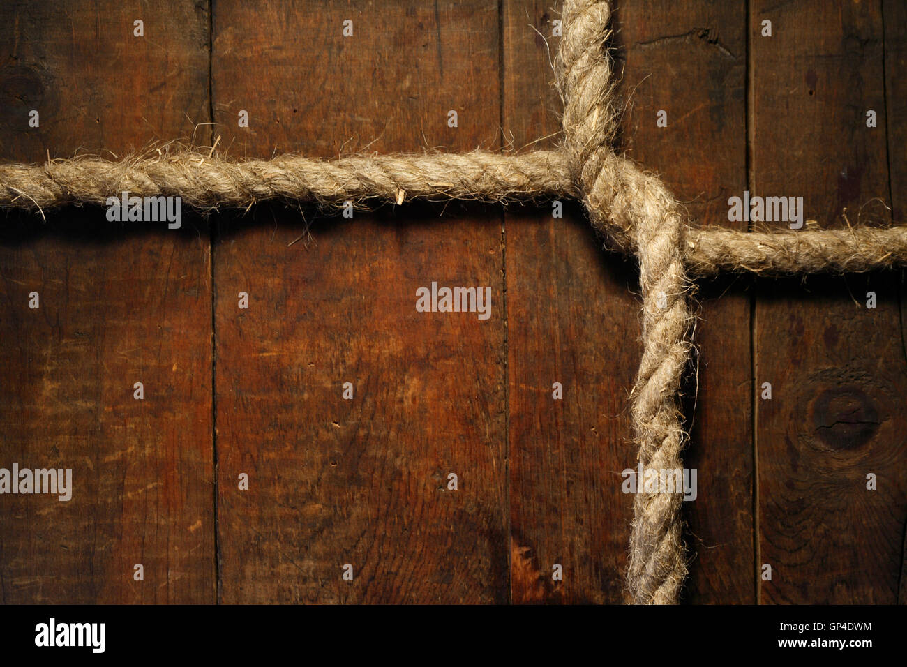 Knotted Rope On Wood Stock Photo - Alamy
