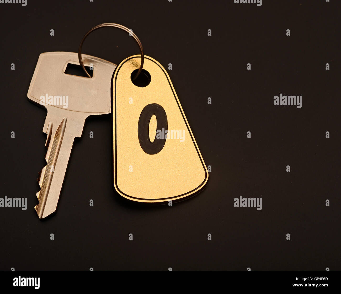 room key on black background with number 0 Stock Photo - Alamy