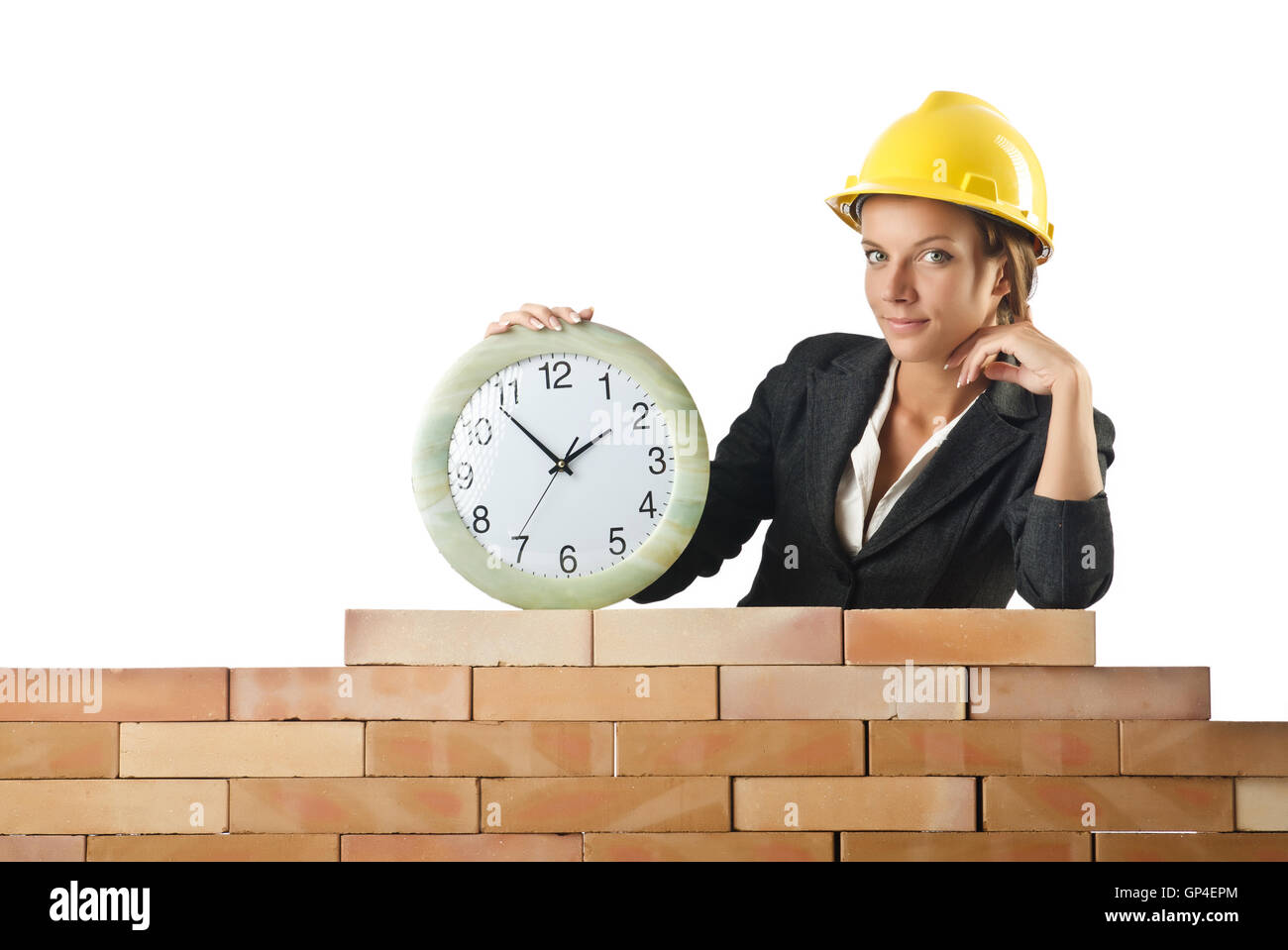 Female builder and clock on white Stock Photo - Alamy