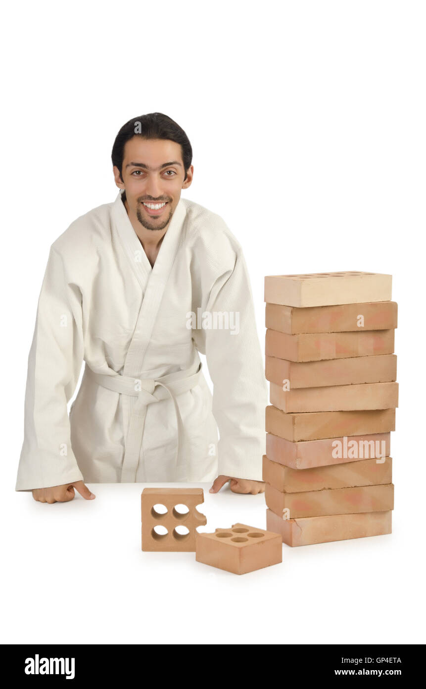Karate man breaking bricks on white Stock Photo - Alamy